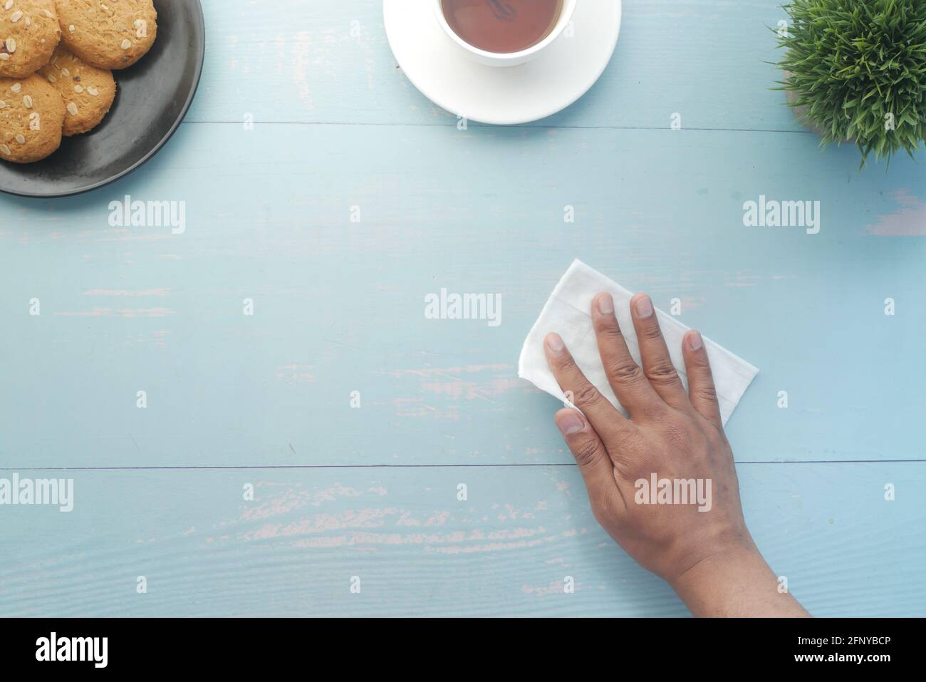 top view of person hand cleaning table with cloth Stock Photo - Alamy