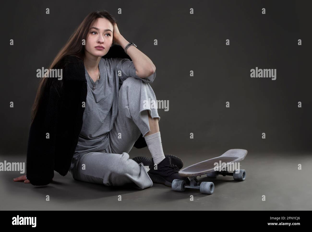 Beautiful girl model with a skateboard in a photo studio Stock Photo ...