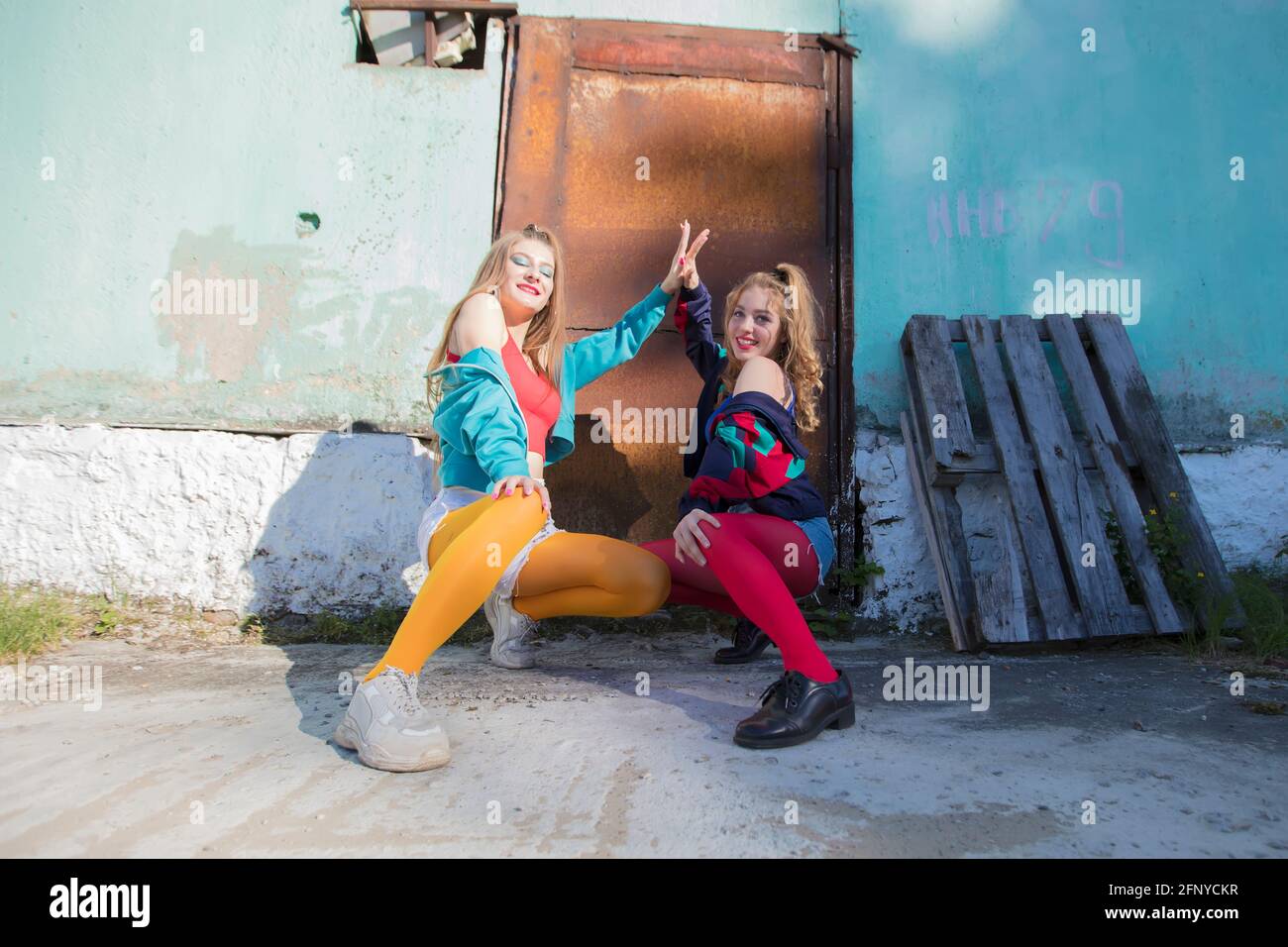 Funny girls in the style of the 90s in bright clothes Stock Photo - Alamy