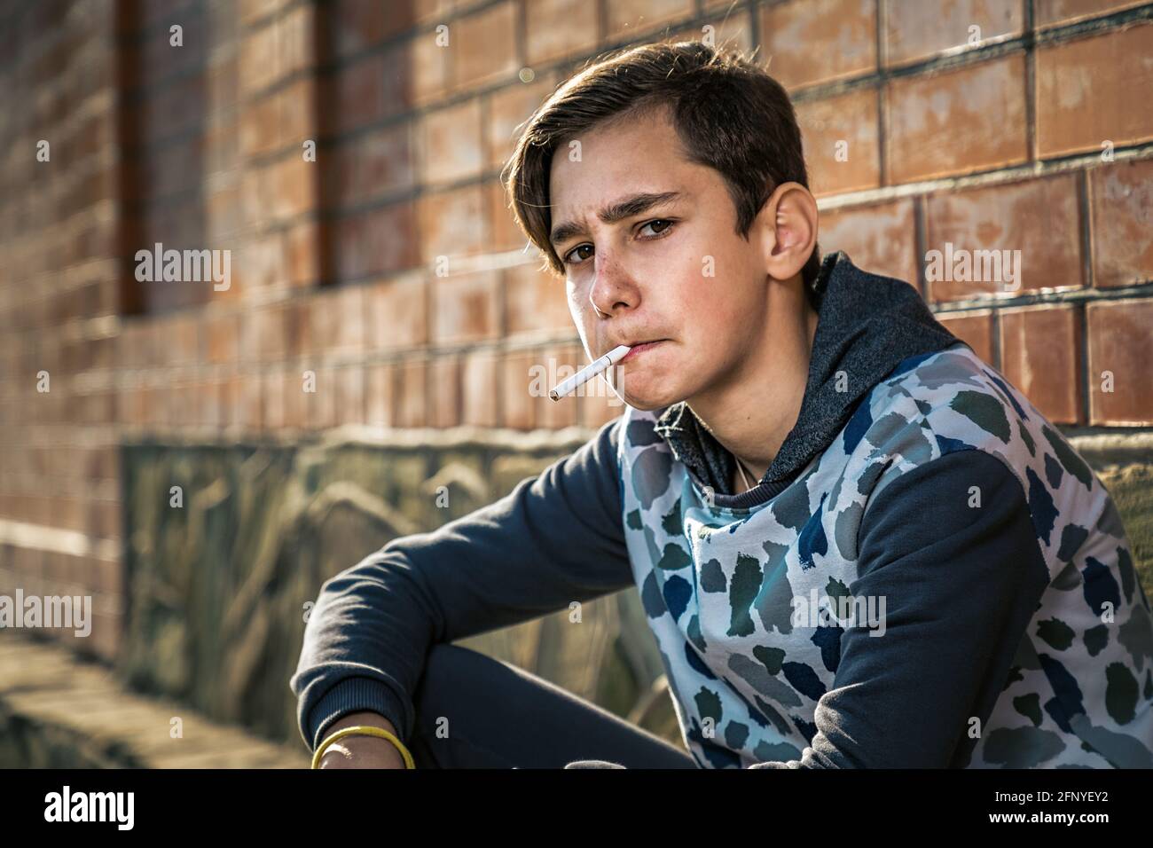 Smoking. Portrait of a teenage Boy Smoking a cigarette with a confident ...