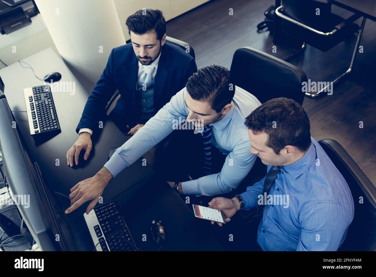 Business team analyzing data on computer Stock Photo - Alamy