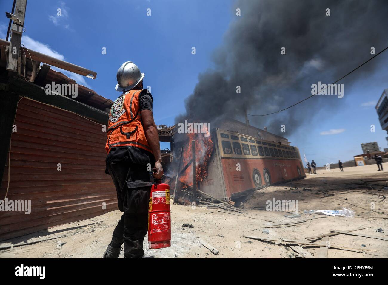 A firefighter risking his life to save others. Smoke rises following ...
