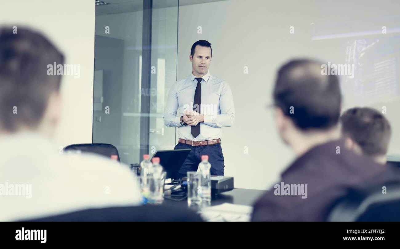 Team leader making presentation on corporate business meeting Stock ...