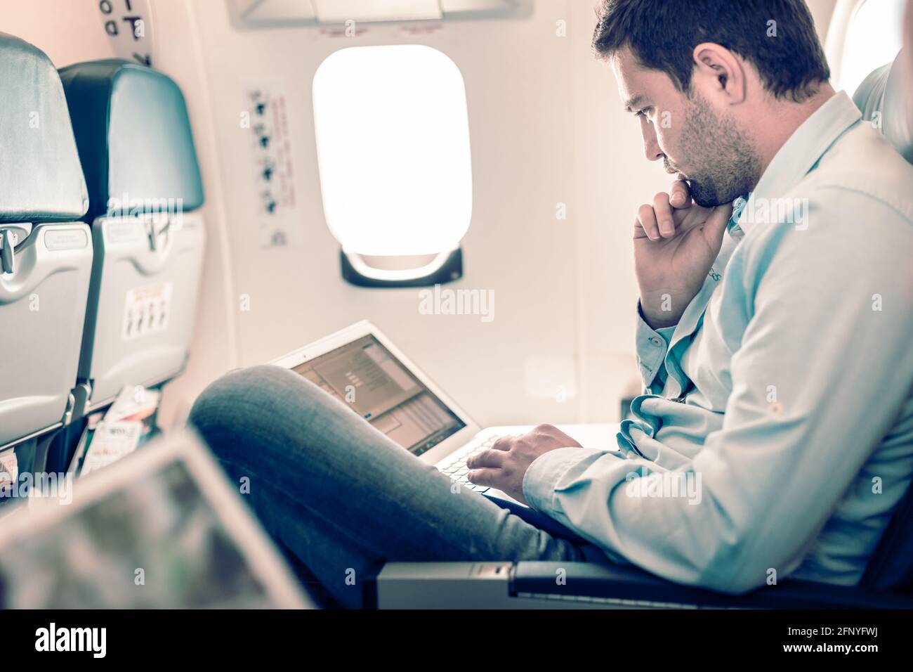 Man sitting on an airplane hi-res stock photography and images - Alamy