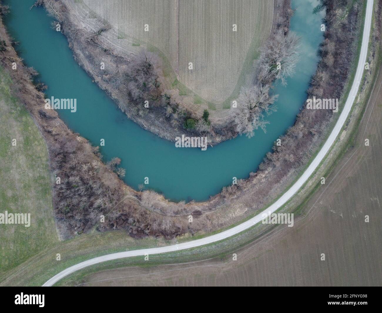 Drone photo of a river turn. It has blue water and some cloud ...