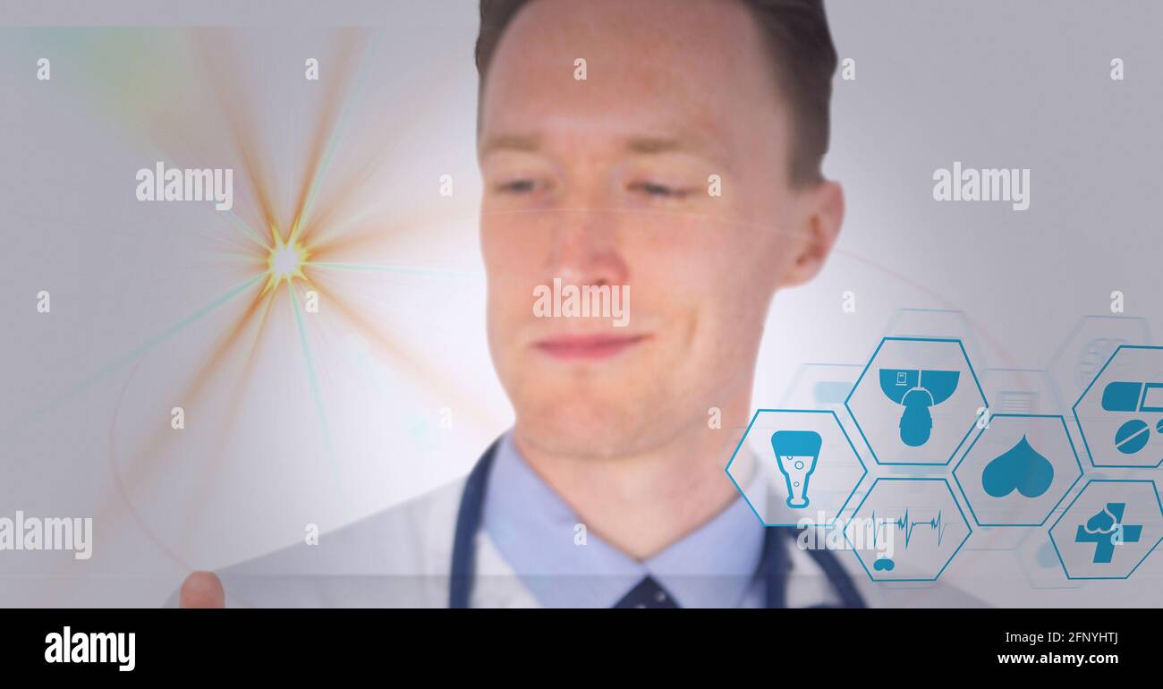 Spot of light and multiple medical icons over caucasian male doctor ...