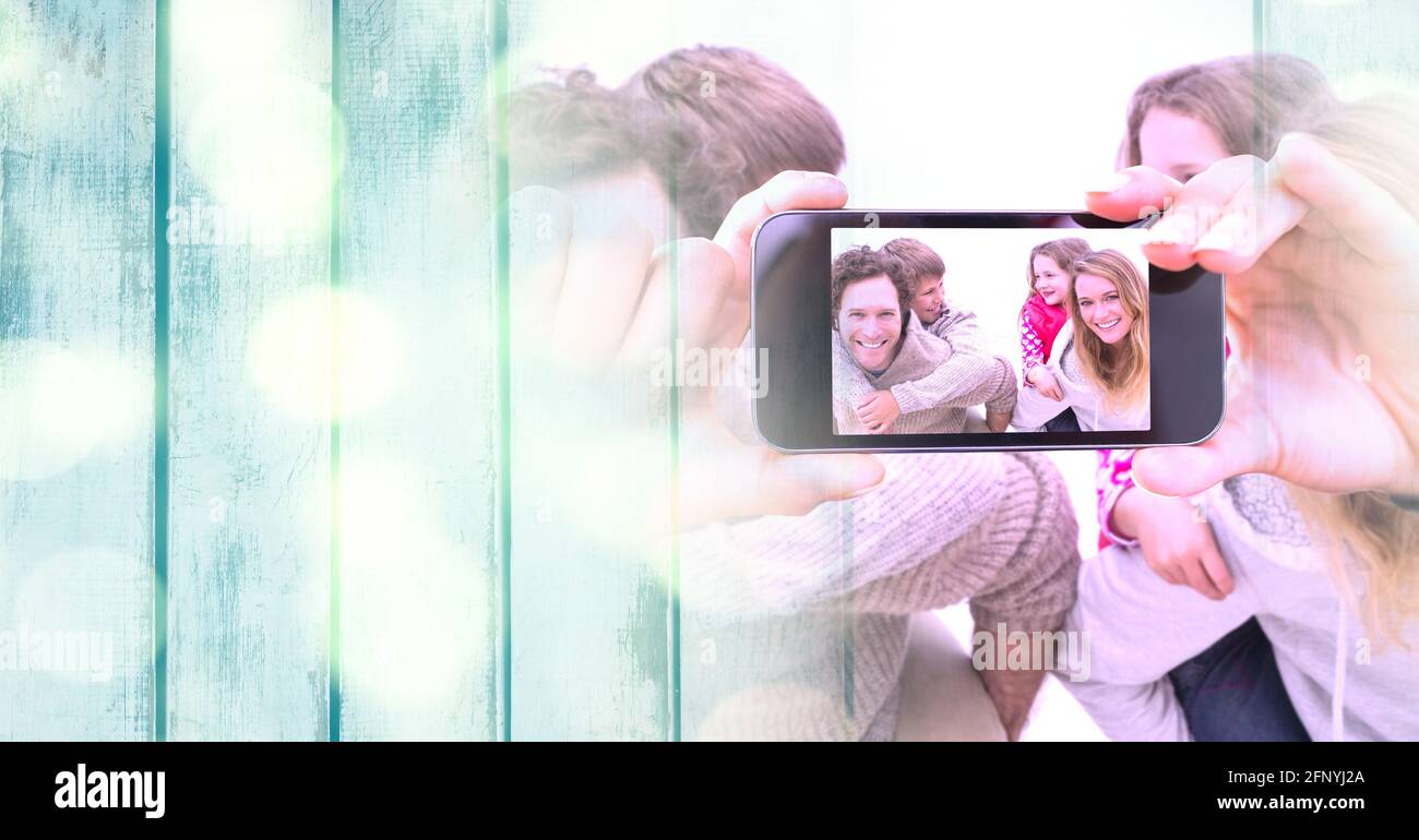 Composition of light circles over happy caucasian family taking selfie ...