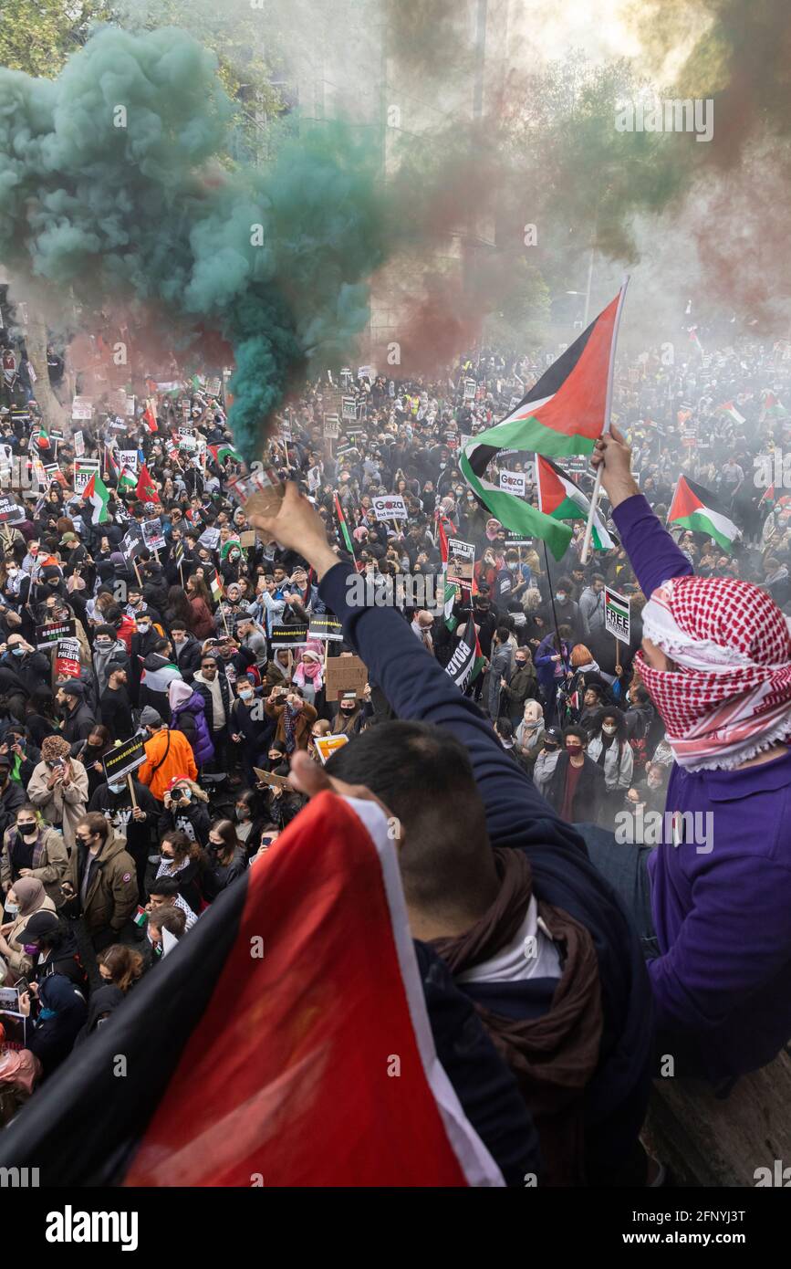 Protesters wave flag and hold smoke bomb above crowd, 'Free Palestine ...