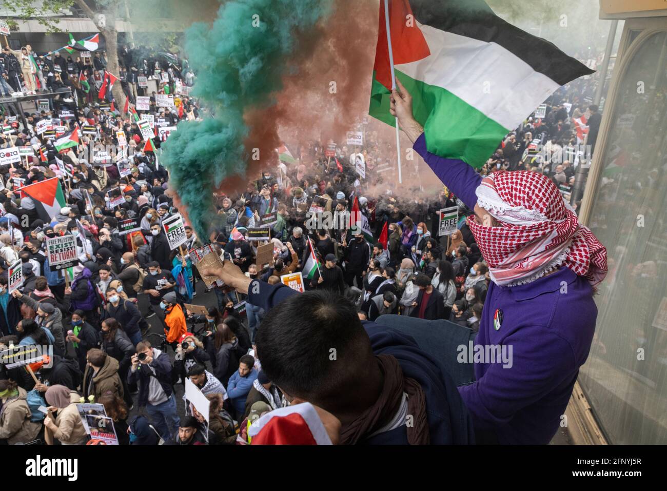 Protesters wave flag and hold smoke bomb above crowd, 'Free Palestine ...