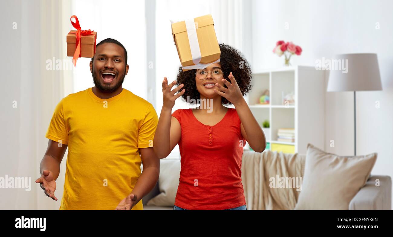 happy african american couple throwing gift boxes Stock Photo - Alamy