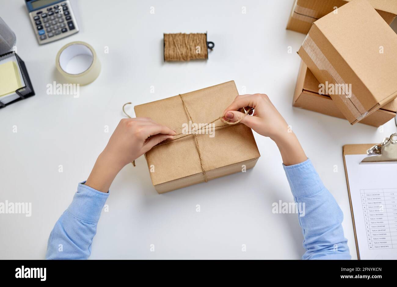 female hands packing parcel box at post office Stock Photo - Alamy