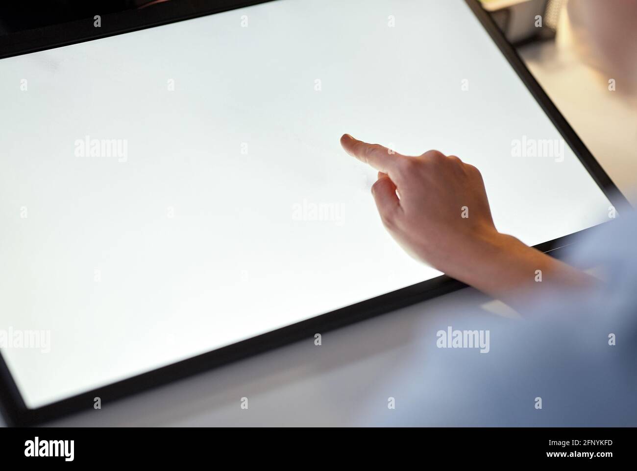 hand on led light tablet at night office Stock Photo - Alamy