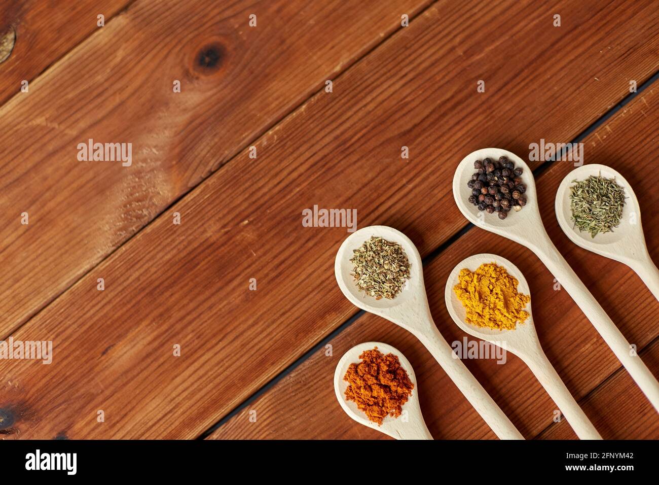 spoons with different spices on wooden table Stock Photo - Alamy