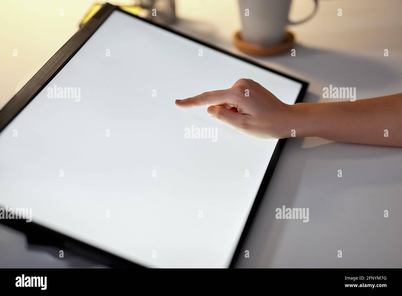 hand on led light tablet at night office Stock Photo - Alamy