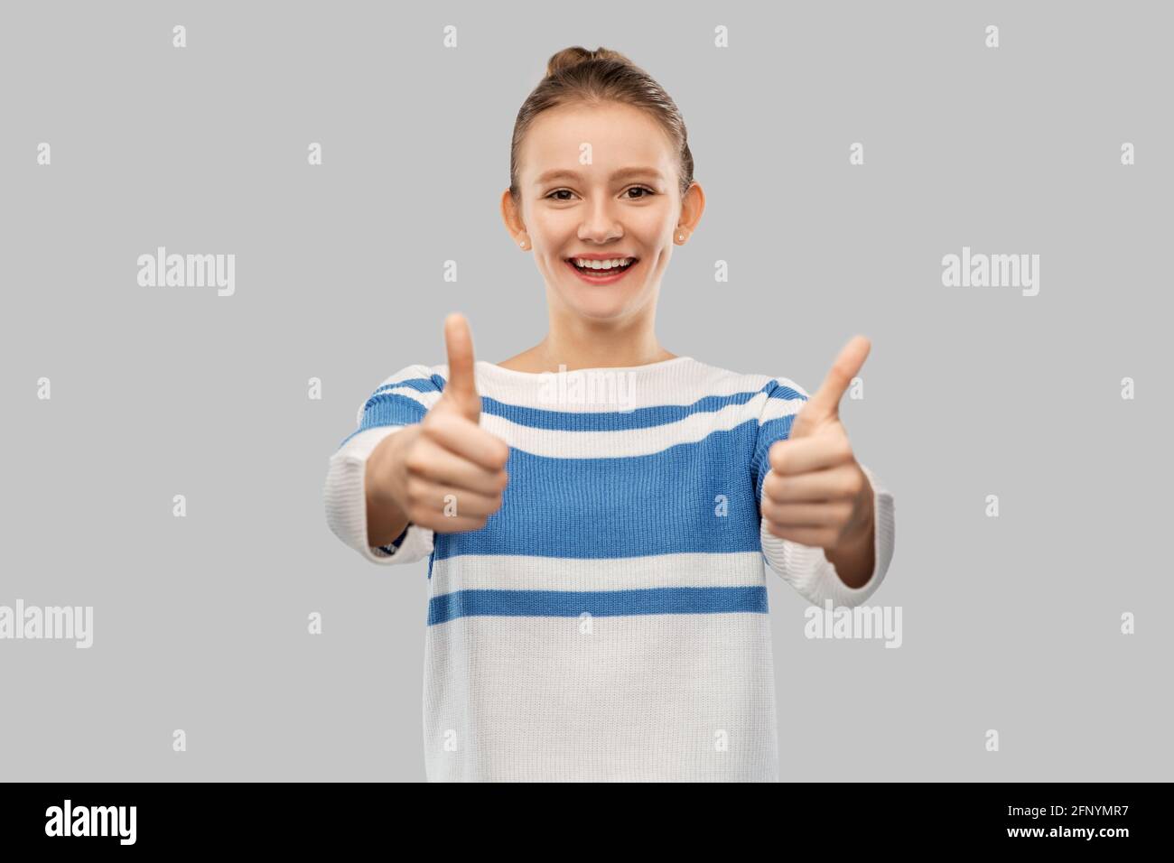 smiling teenage girl showing thumbs up Stock Photo - Alamy