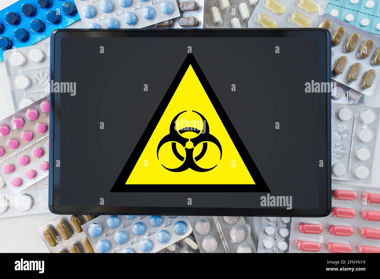 boihazard caution sign, tablet pc and drugs Stock Photo - Alamy