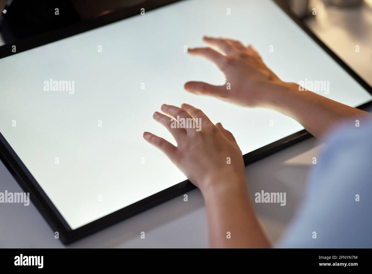 hands on led light tablet at night office Stock Photo - Alamy