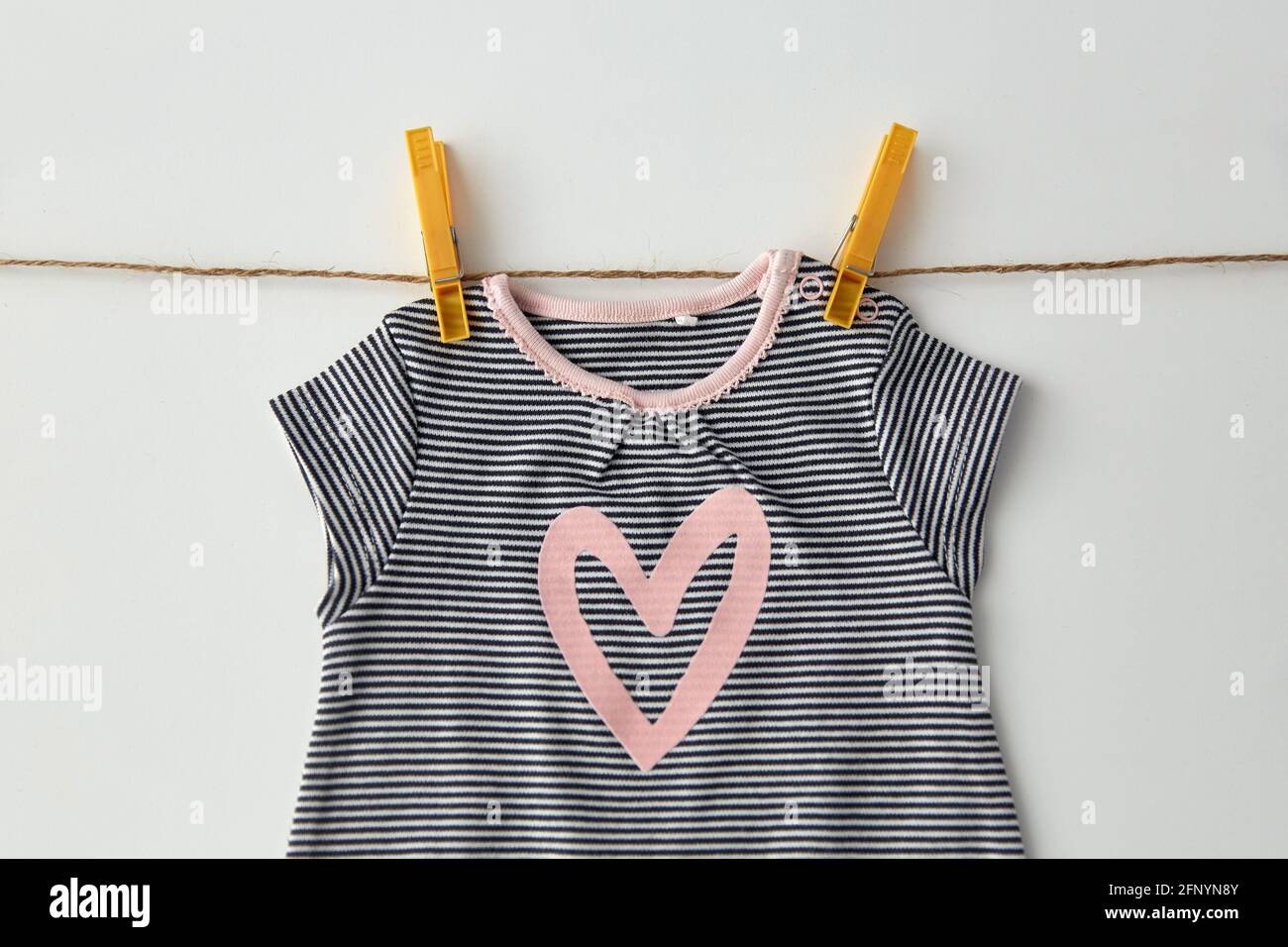 Baby clothes hanging on clothesline hi-res stock photography and images ...