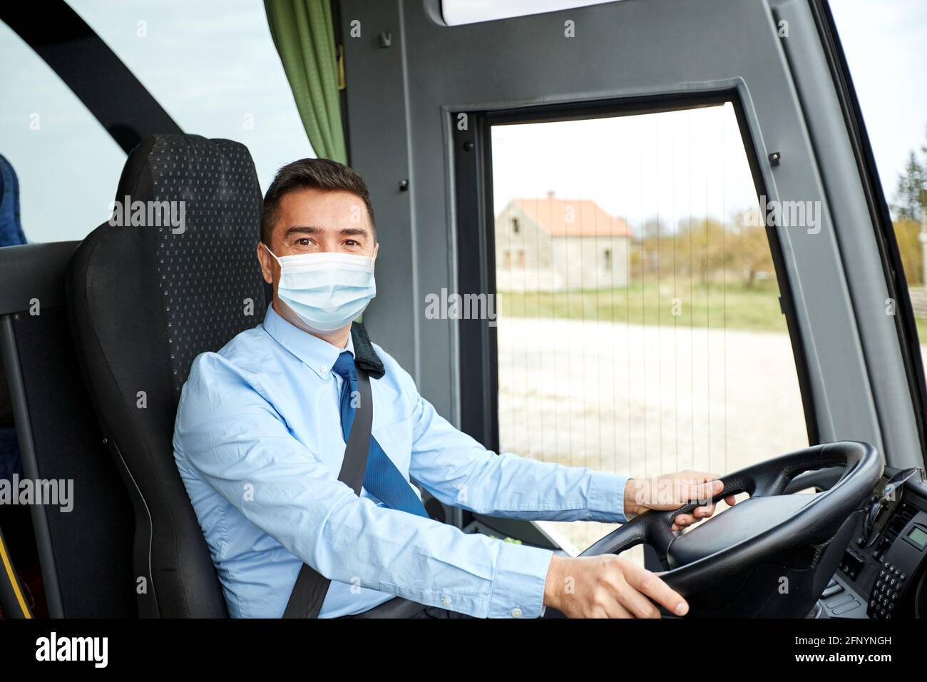 driver in medical mask driving intercity bus Stock Photo - Alamy