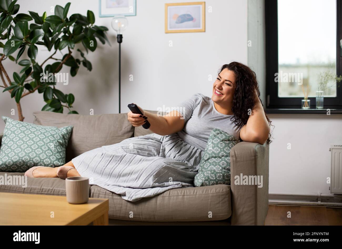 Woman remote control hi-res stock photography and images - Alamy