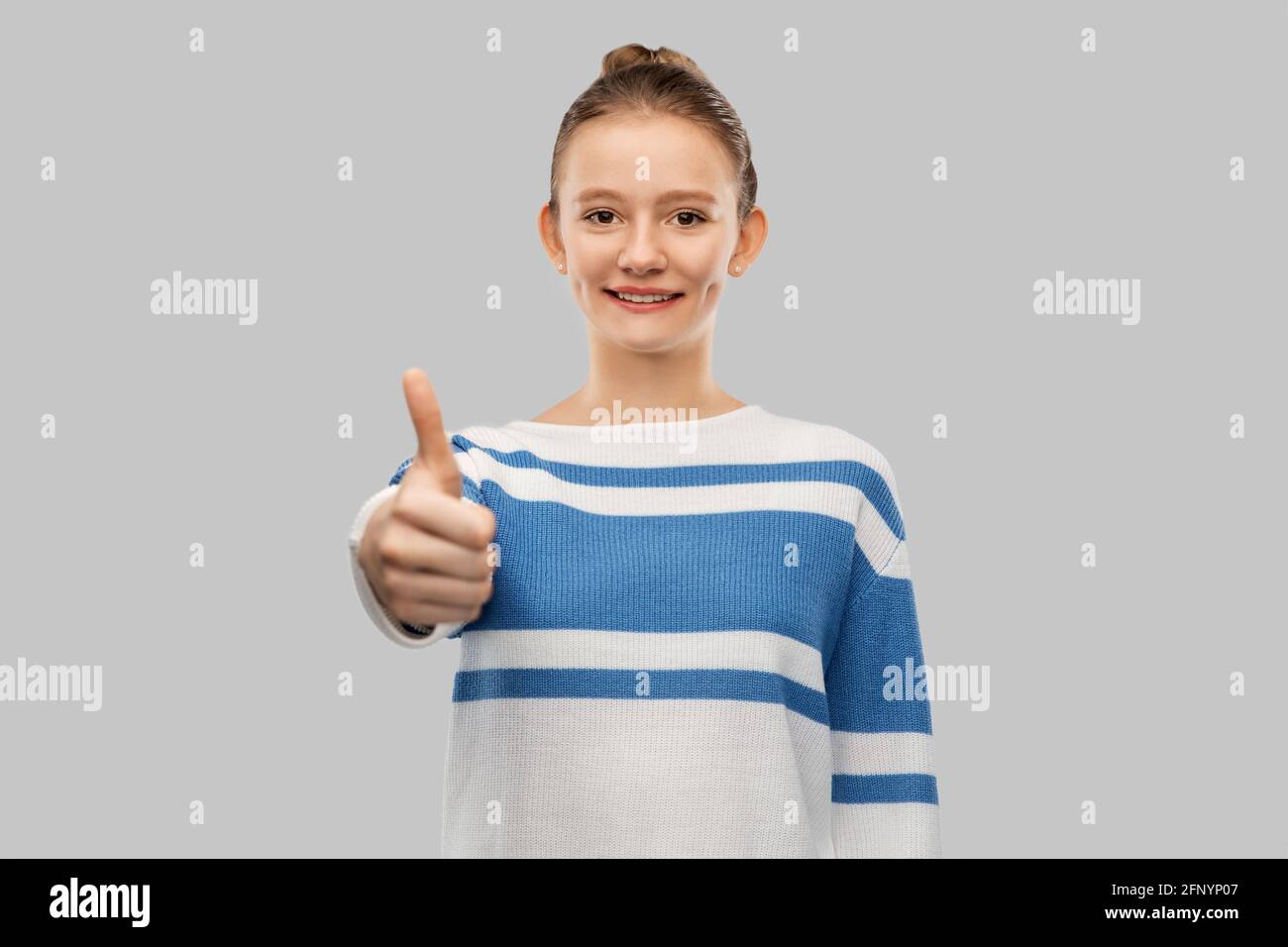 smiling teenage girl showing thumbs up Stock Photo - Alamy