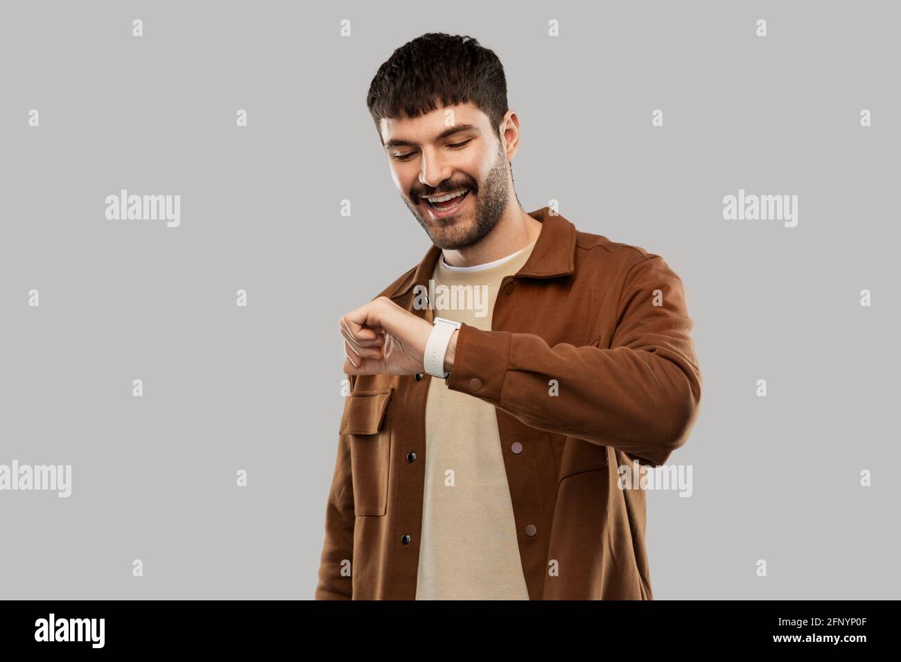 smiling young man with smart watch Stock Photo - Alamy