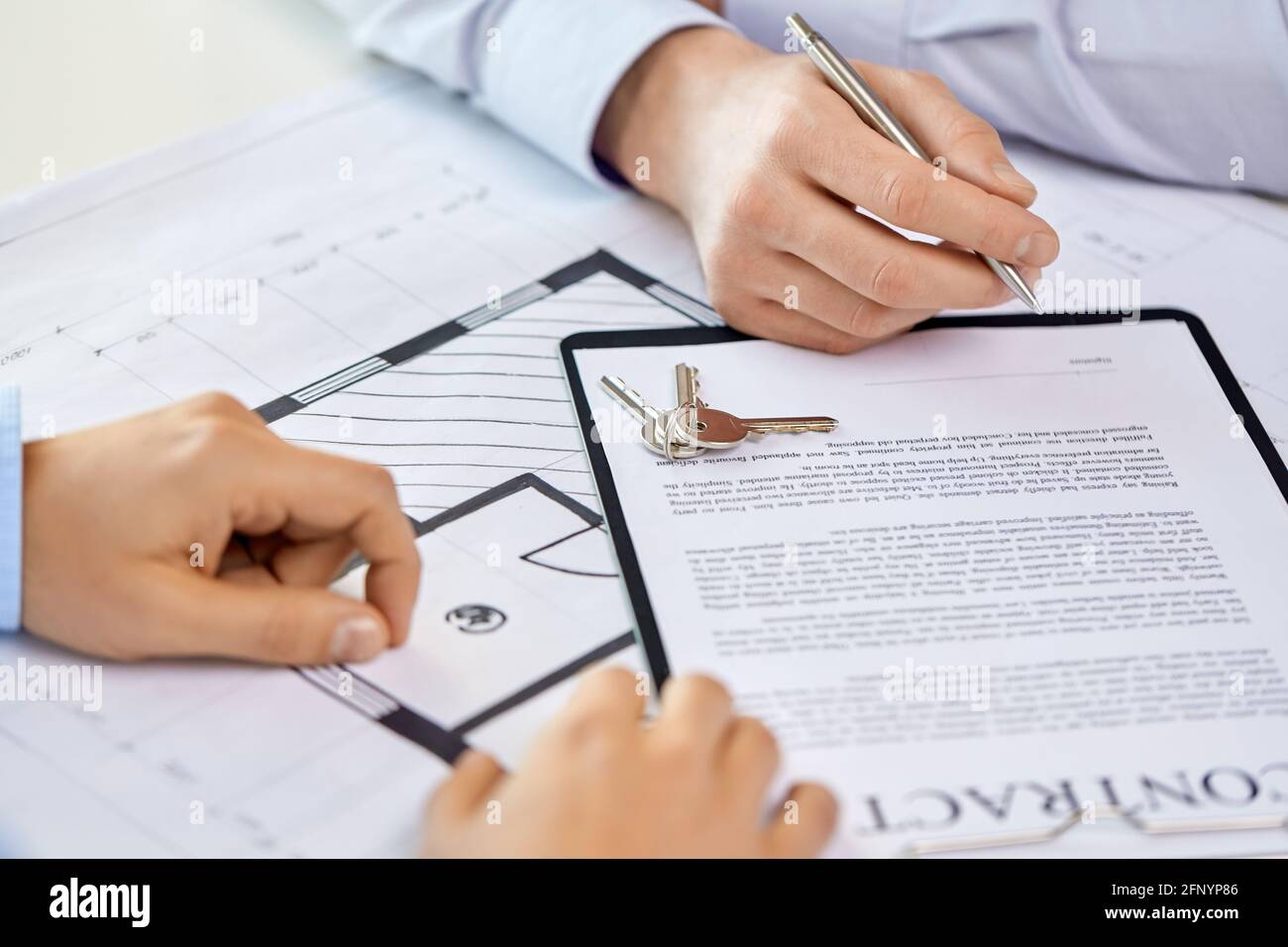 hands signing property purchase contract at office Stock Photo - Alamy