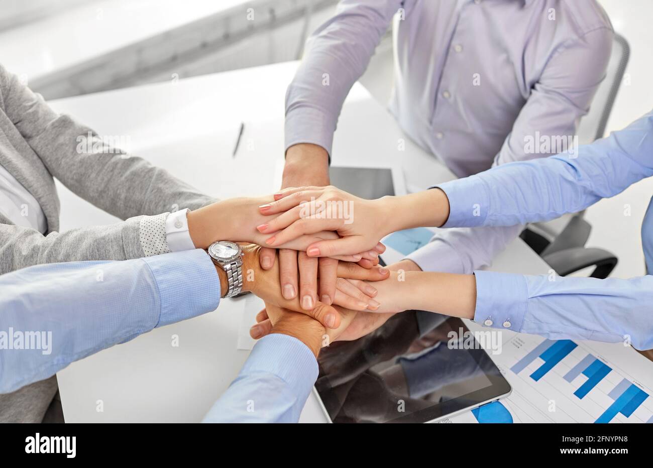 close up of business team stacking hands at office Stock Photo - Alamy