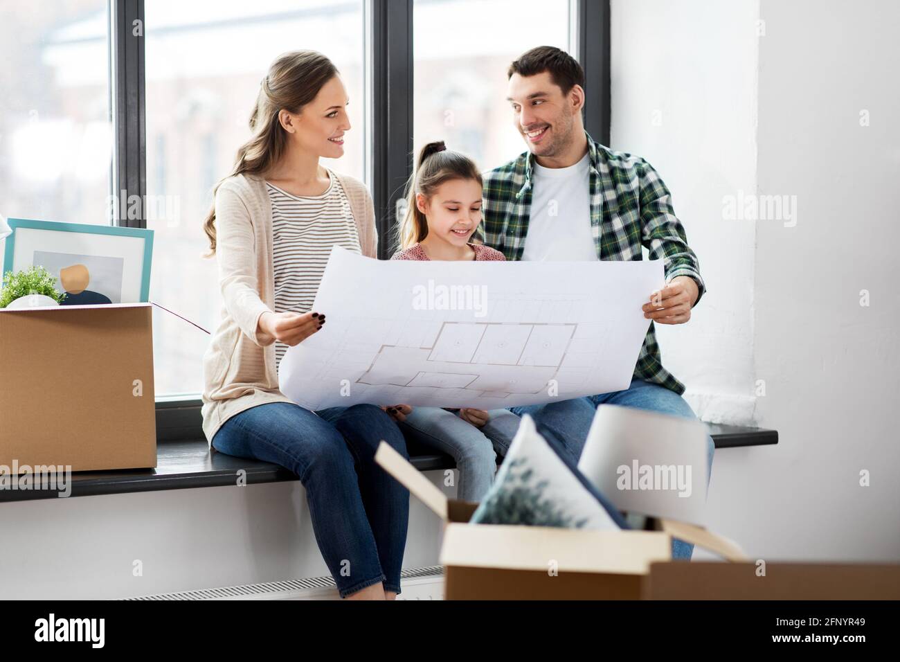 happy family with blueprint moving to new home Stock Photo - Alamy