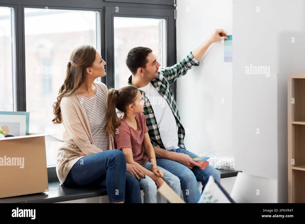 happy family with color palette moving to new home Stock Photo - Alamy