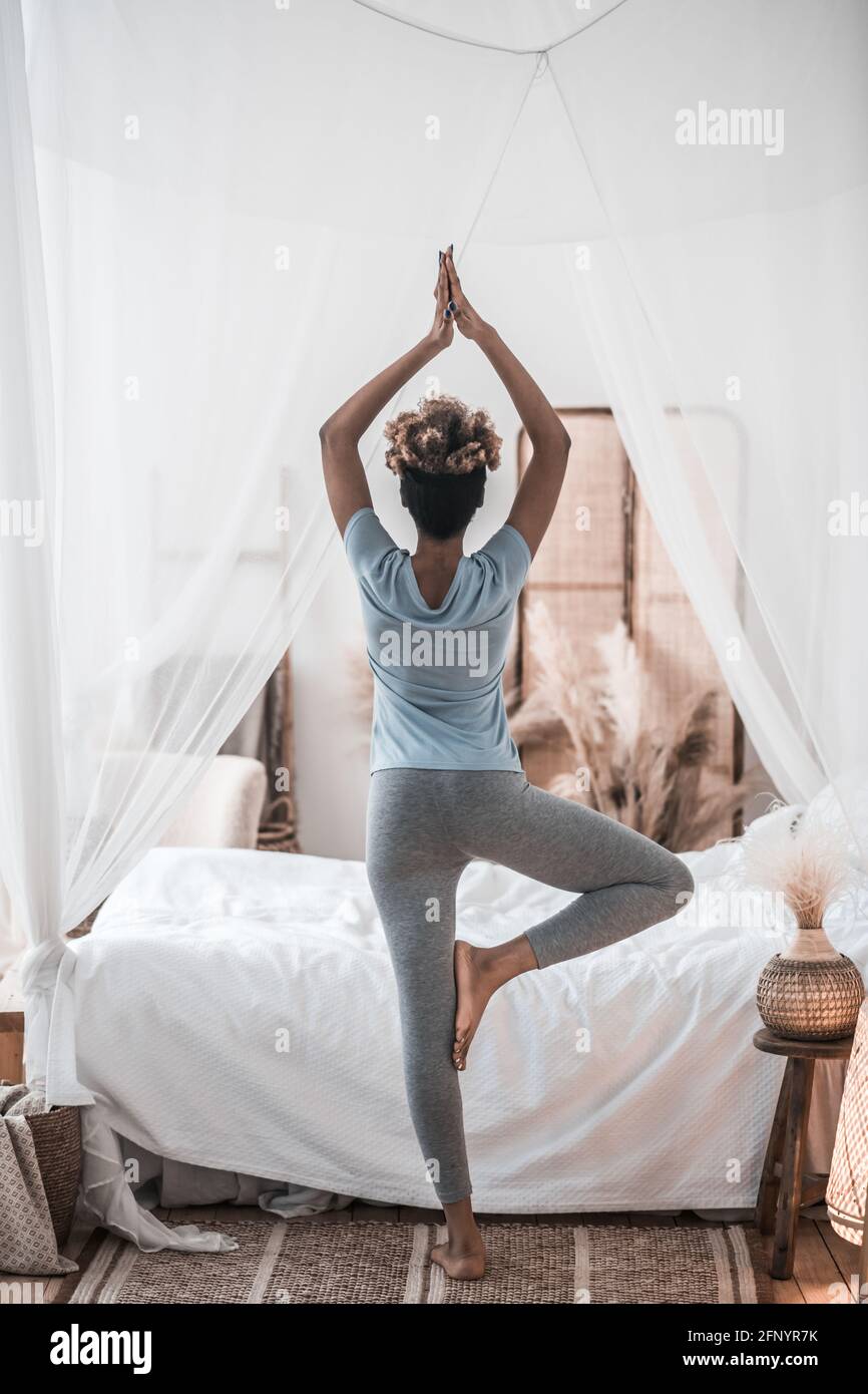 View back of woman standing with raised arms Stock Photo - Alamy