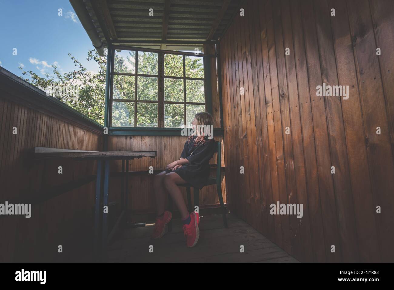 wooden cottage lounge in the garden with girl Stock Photo - Alamy