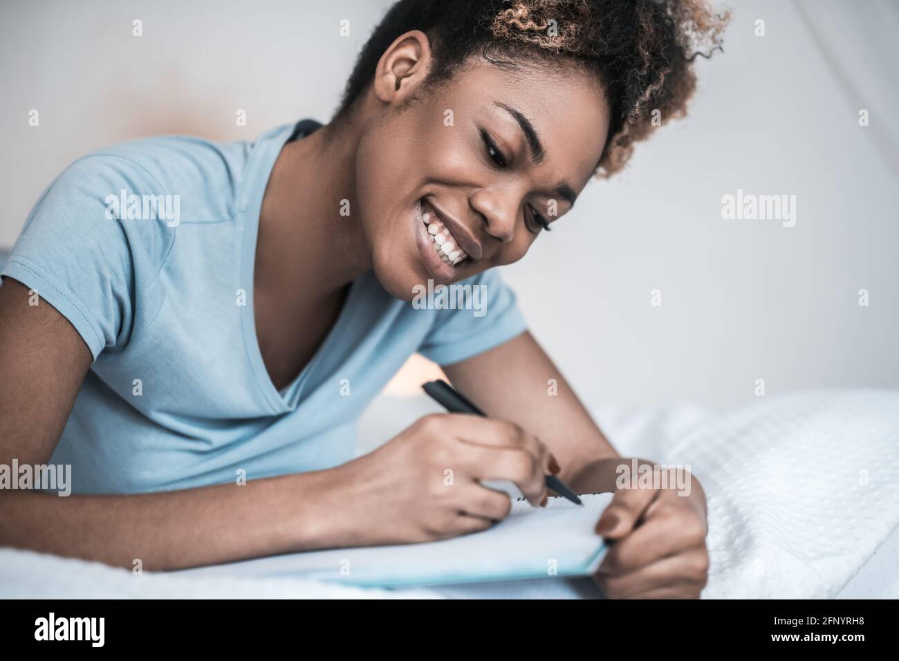 African american woman writing with pen in notebook Stock Photo - Alamy