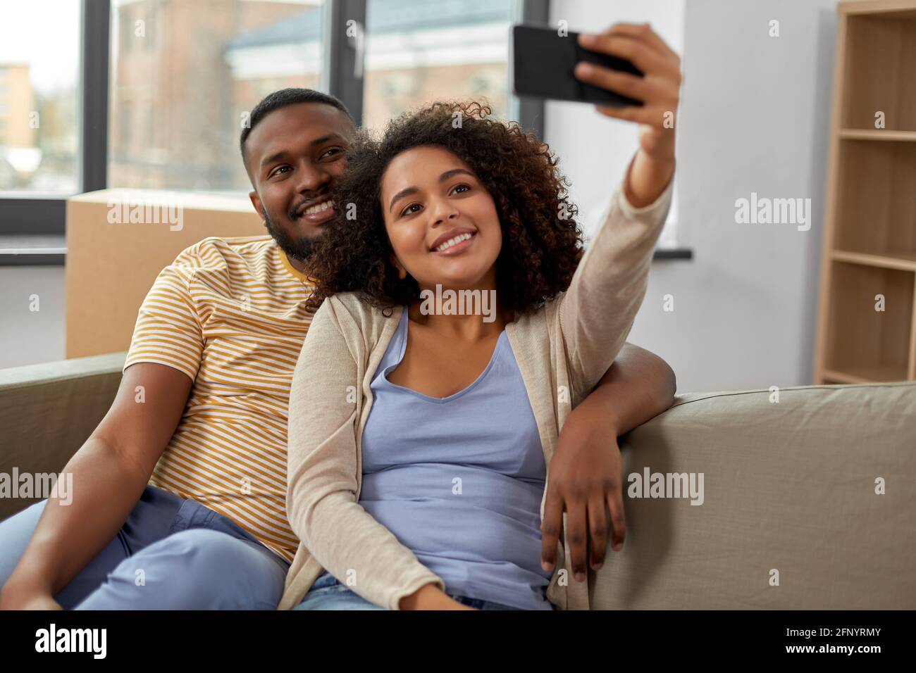 happy couple moving to new home and taking selfie Stock Photo - Alamy