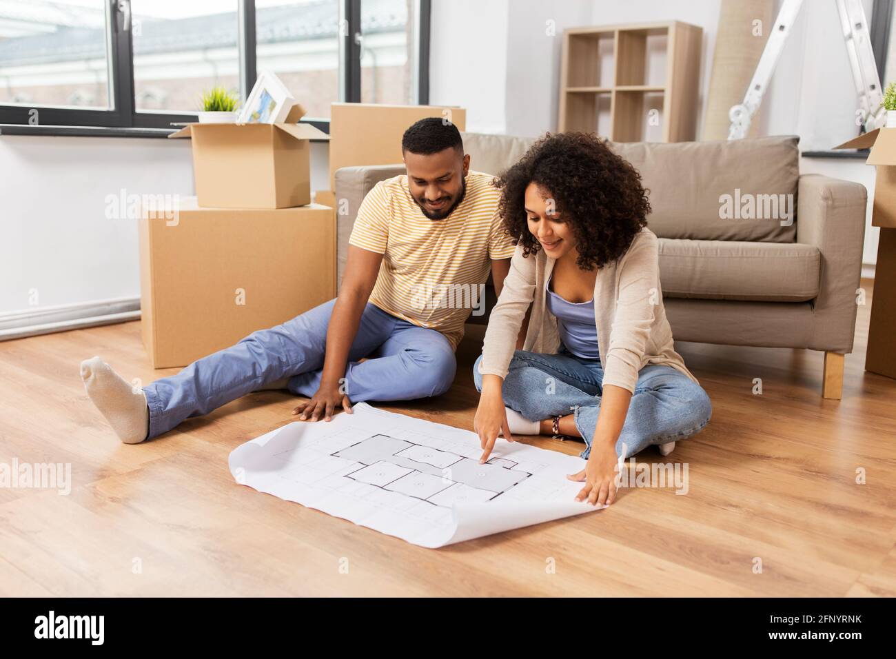 couple with boxes and blueprint moving to new home Stock Photo - Alamy