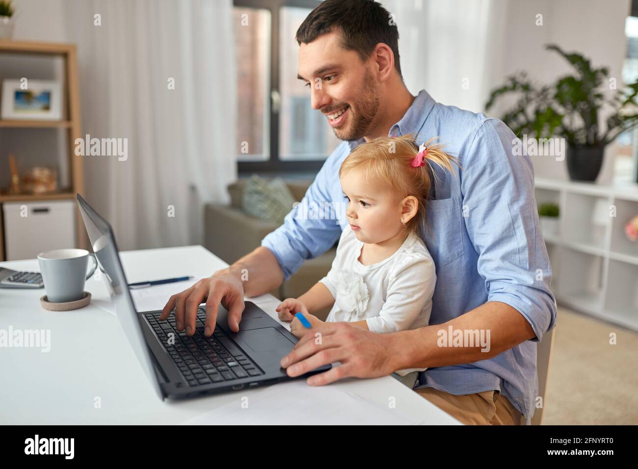Busy father working laptop hi-res stock photography and images - Alamy