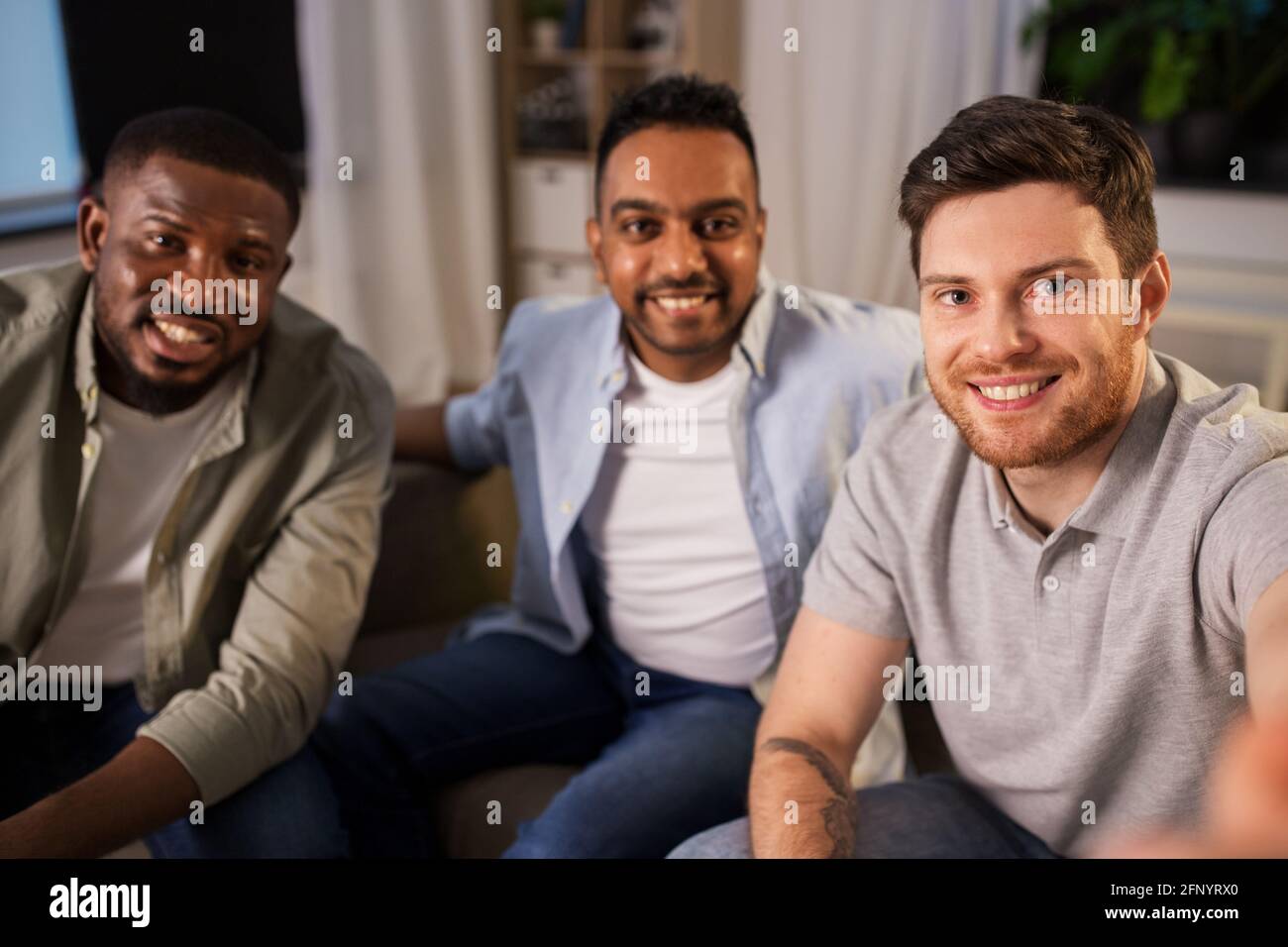 happy male friends taking selfie at home Stock Photo - Alamy