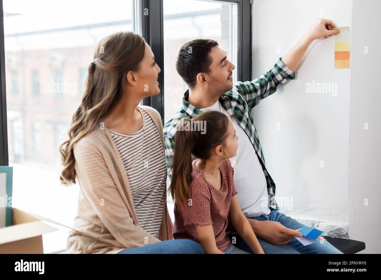 happy family with color palette moving to new home Stock Photo - Alamy