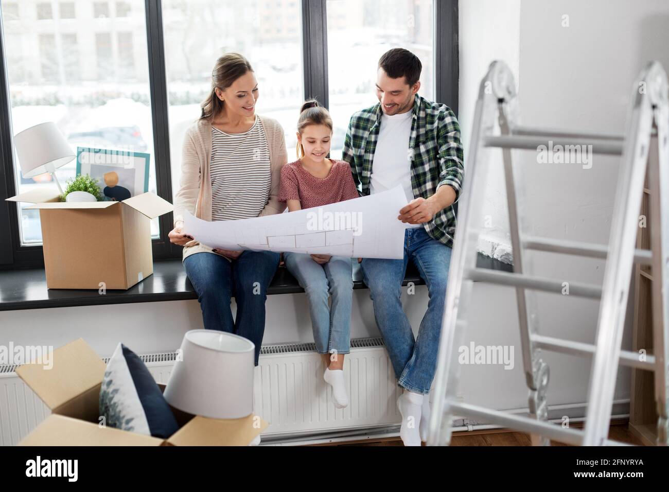 happy family with blueprint moving to new home Stock Photo - Alamy