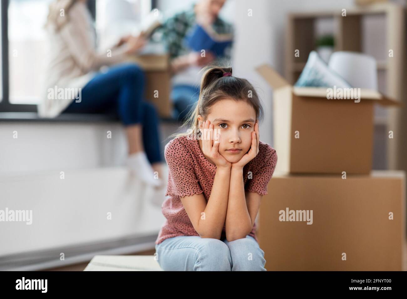 sad girl moving to new home with her family Stock Photo - Alamy