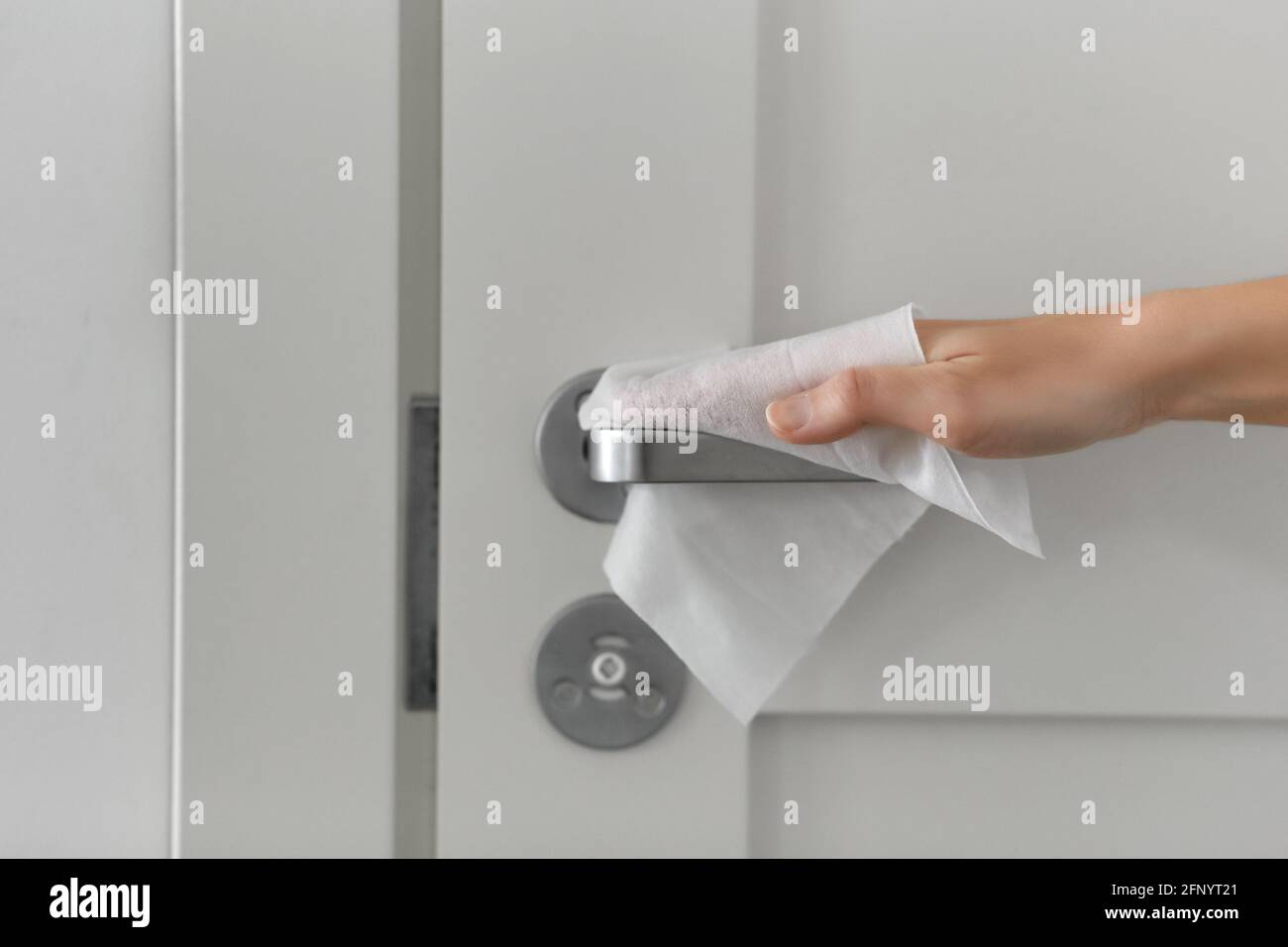 hand cleaning door handle with antiseptic wet wipe Stock Photo - Alamy