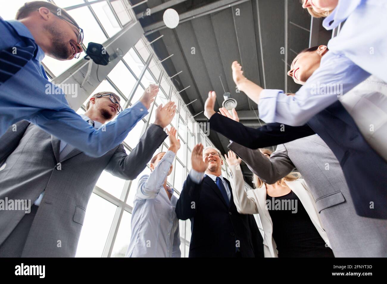 business people making high five at office Stock Photo - Alamy