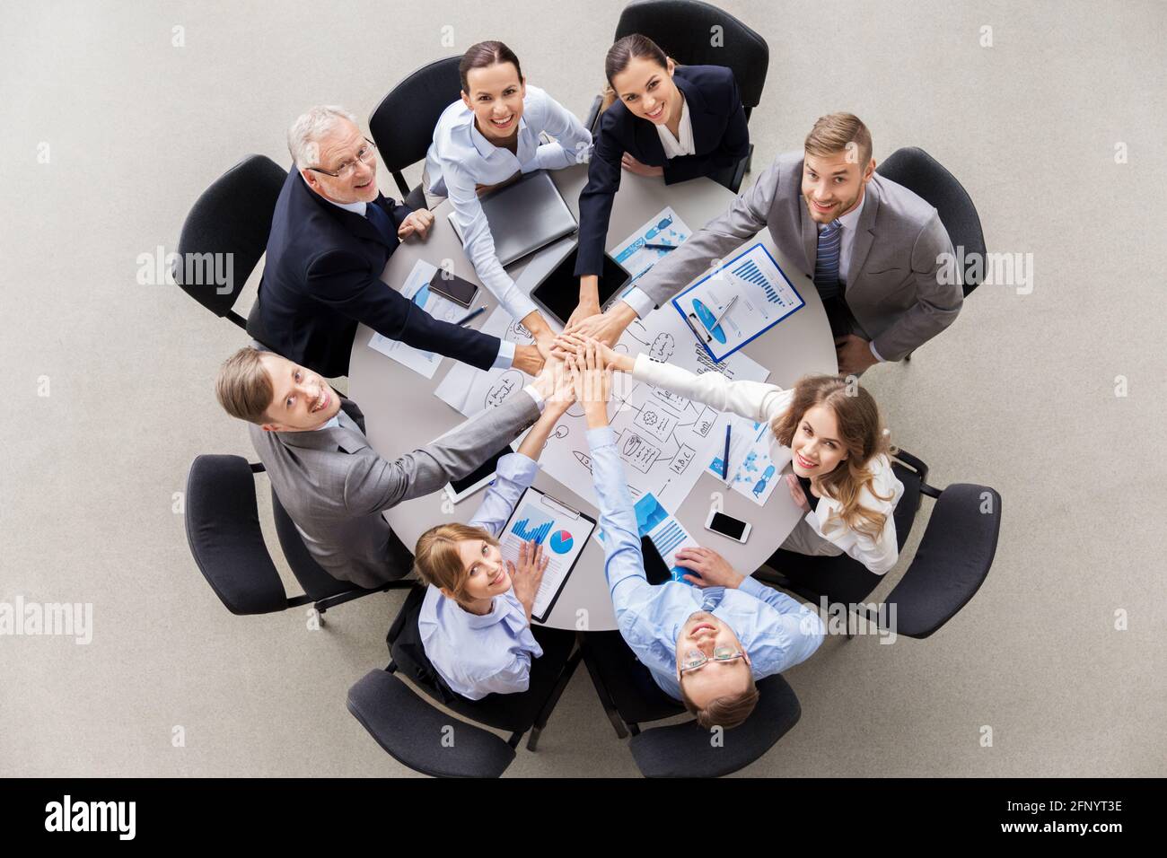 happy business people stacking hands Stock Photo - Alamy
