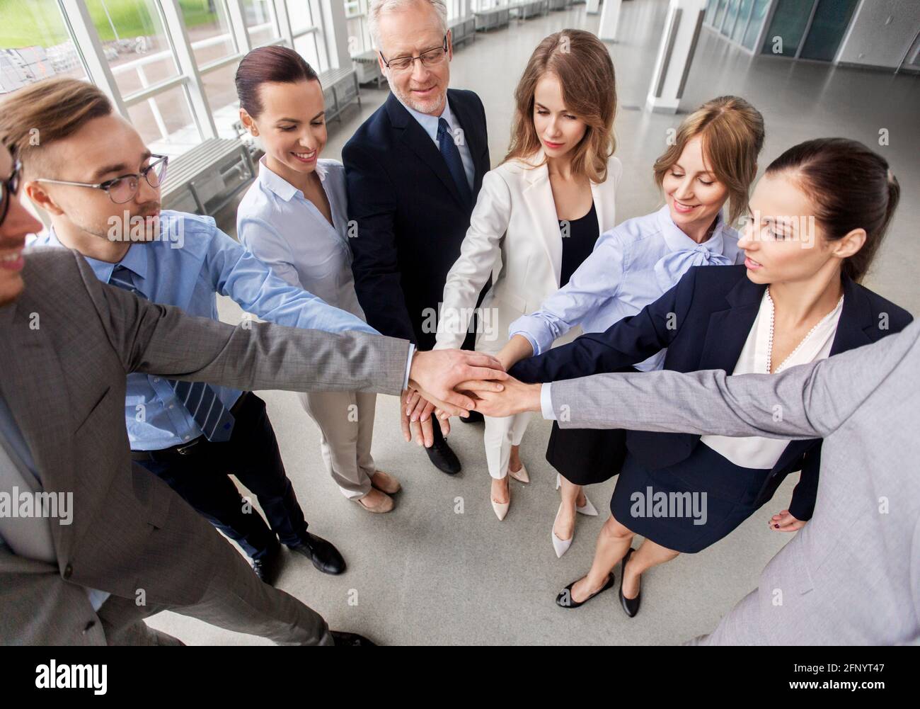 happy business people stacking hands at office Stock Photo - Alamy