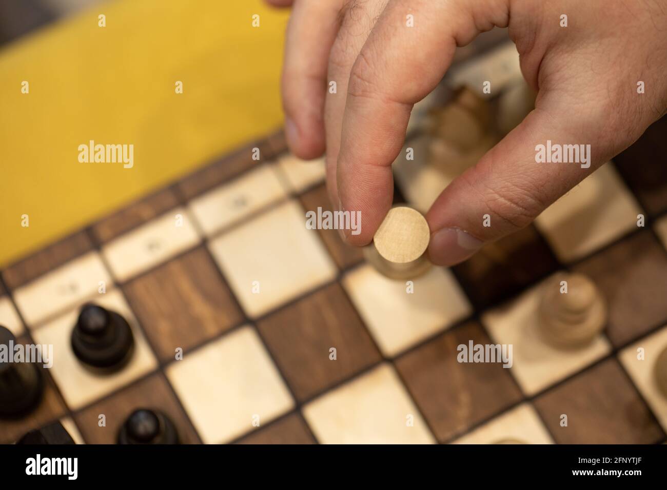 Hand taking next step on chess game. Human hand moving wooden white ...