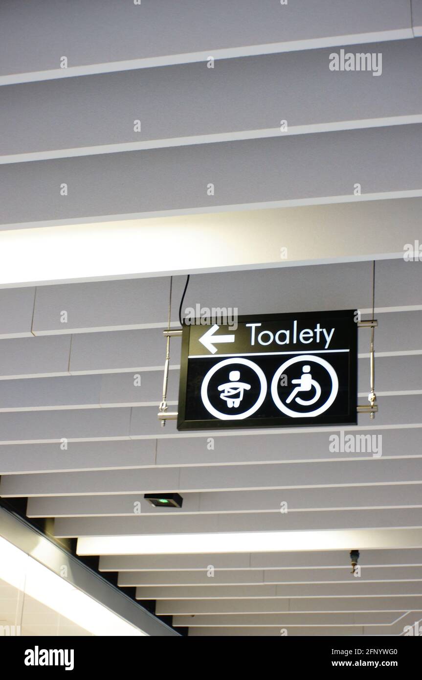 Sign showing the way to the toilets hanging from the roof Stock Photo ...