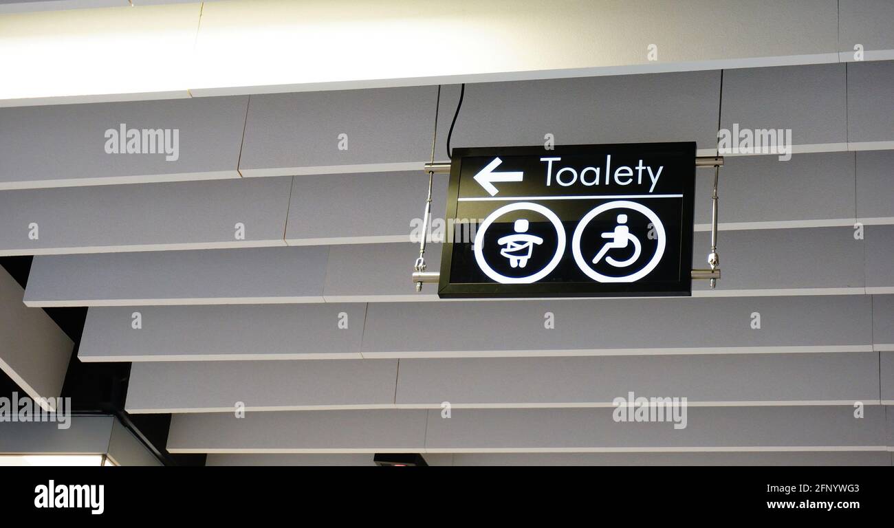 Sign showing the way to the toilets hanging from the roof Stock Photo ...