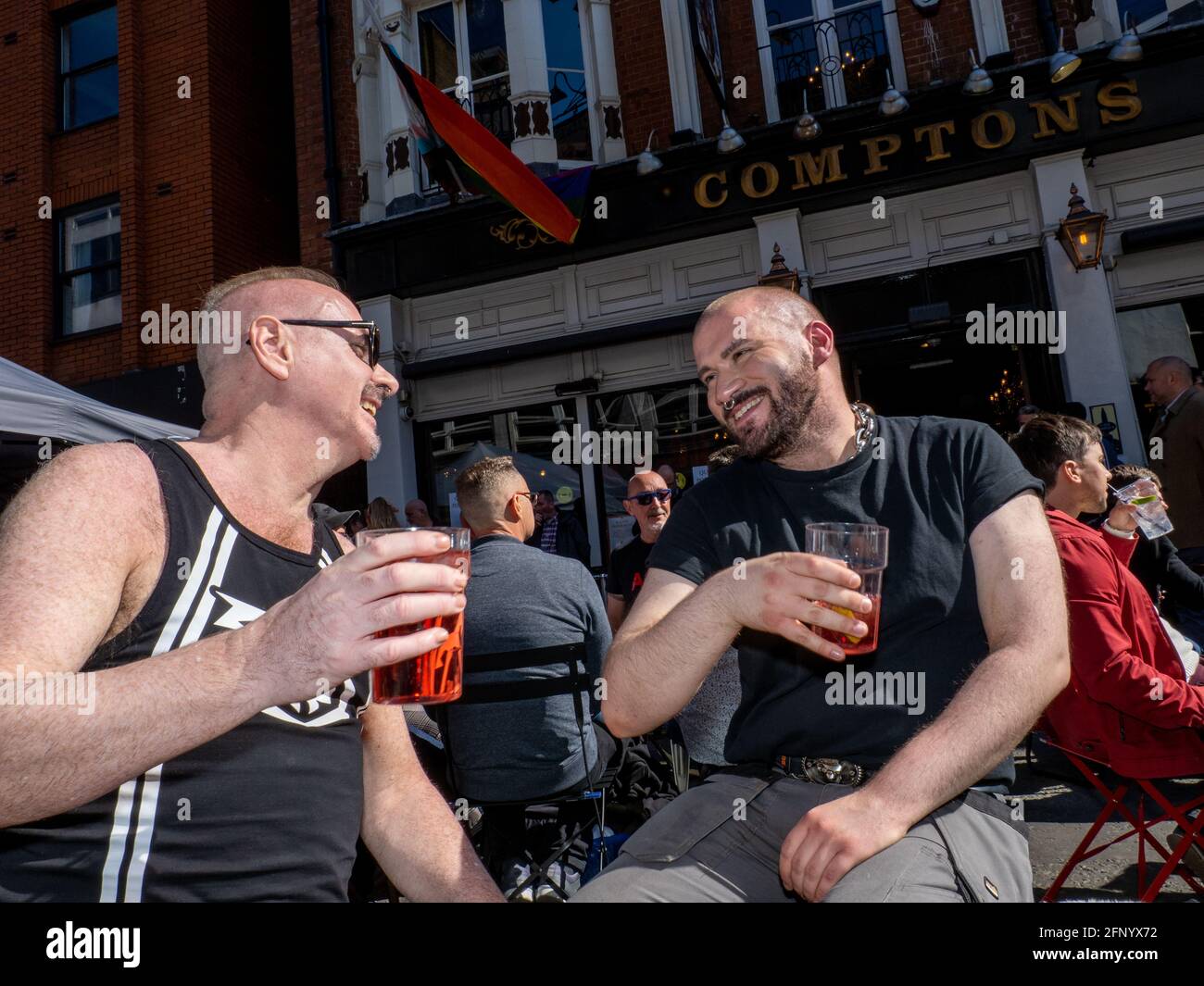 Ian and Chris drink in a sun spot along Old Compton Street, Soho Stock ...