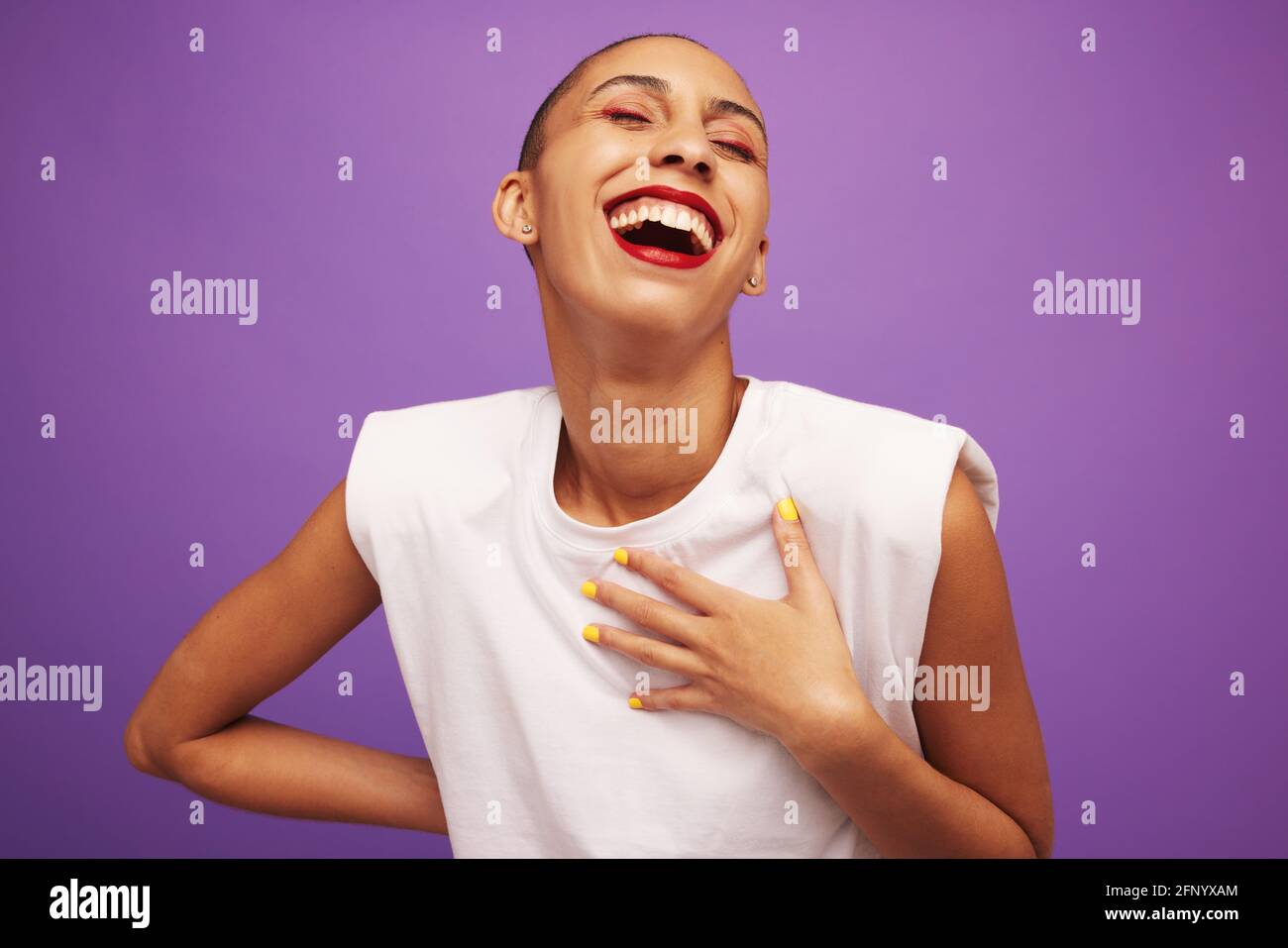 Pretty female in white top smiling on studio background. Happy looking ...