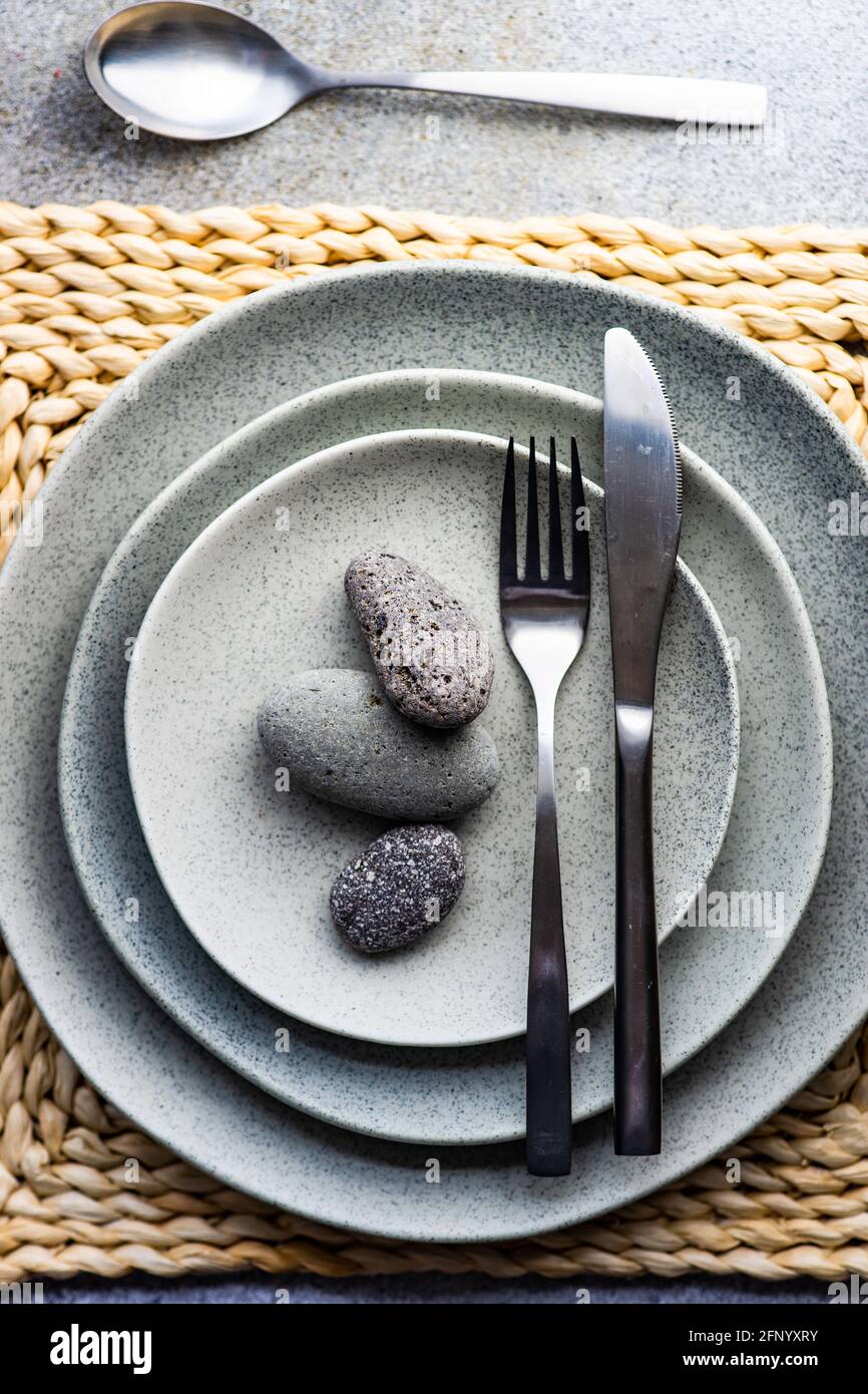 Overhead view of a rustic place setting with pebbles Stock Photo - Alamy